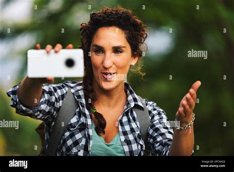 Human Photographer Is Taking Cell Phone Pictures Of Someone And Giving Them Directions On How To