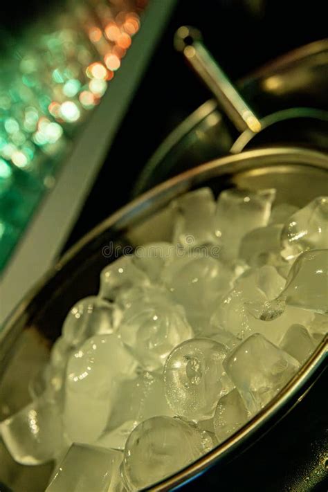 Chilled Ice Cubes Placed In A Metallic Bowl Surrounded By Soft Ambient Lighting Effects Stock