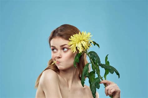 Women With Yellow Flower On Head On Blue Background Naked Shoulders