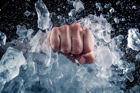 Premium Photo Action Shot Of Fist Punching Into A Wall Of Ice Shards