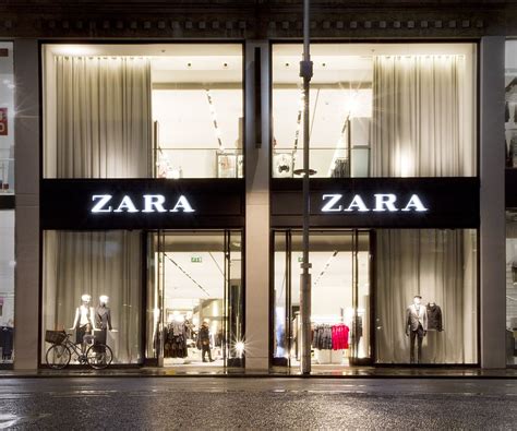 A Store Front With The Word Zara Lit Up At Night