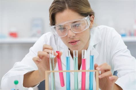 Young Woman Looking Into Conical Flask Coloured Solution Stock Image Image Of Face Human