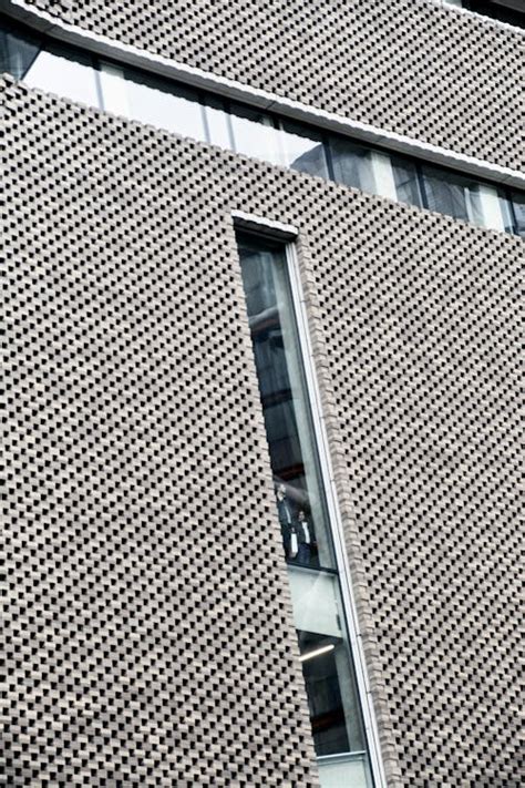 Free Modern Facade Featuring Geometric Design With Narrow Vertical Window Showcasing Minimalism