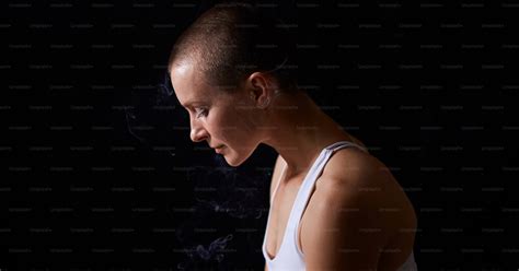 명상하는 여자는 검은 방에서 집에서 명상하고 요가를 연습 할 때 아로마 스틱을 사용합니다 흰색 운동복을 입은 짧은 머리와 딱 맞는 여성 요기 사진 Unsplash의