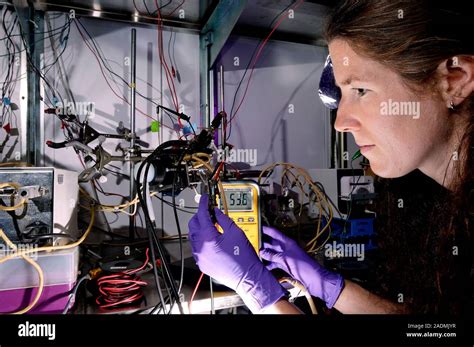 Microbial Fuel Cell Researcher Testing The Electrical Output Of A Microbial Fuel Cell This
