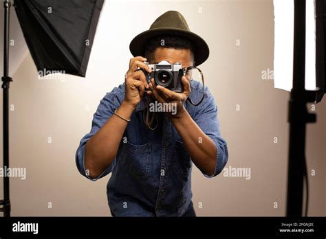 Man Clicking Photo Using Camera In Studio Stock Photo Alamy
