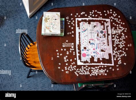 Unsolved jigsaw puzzle on a wooden table Stock Photo - Alamy