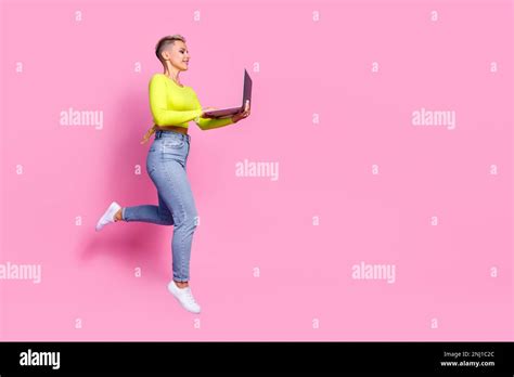 Full Size Profile Photo Of Attractive Active Girl Jumping Run Use Netbook Empty Space Isolated