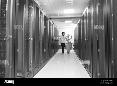 Engineer Showing Working Data Center Server Room To Female Chief Stock