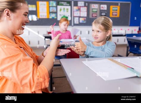 Practicing Sign Language Female Teacher And Student In School