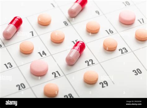 Pills Are Of Different Color On The Calendar Schedule Medication Focus On A Light Green Pill
