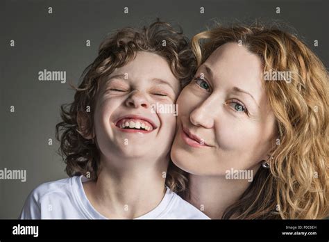 Close Up Portrait Of Mother With Cheerful Son Over Gray Background Stock Photo Alamy