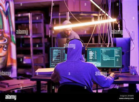 Hacker In Headphones Listening To Music While Cracking Password On