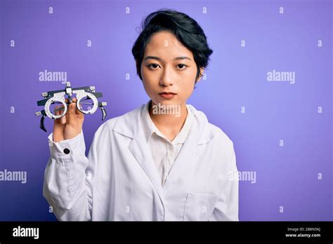 Beautiful Asian Optical Girl Wearing Coat Holding Optometry Glasses