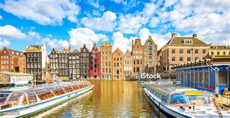 Amsterdam City Skyline And Dancing Houses Over Damrak Canal Netherland