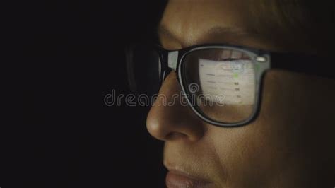 A Female Face In Glasses With The Reflection Of A Monitor With An