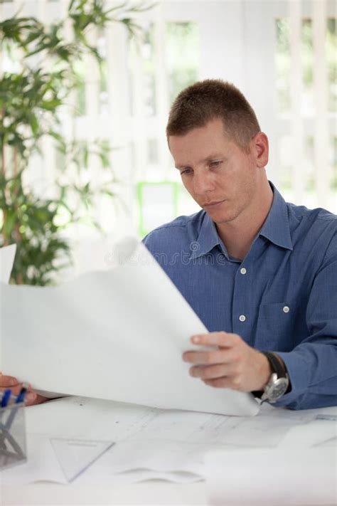 Concentrated Businessman Analyzing Graphs In His Office Stock Image