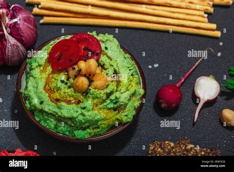 Various Hummus Dips Fresh Vegetables And Herbs Crispy Bread Snacks