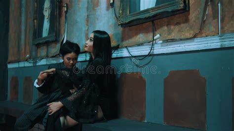Stylish Couple Posing In A Vintage Room With Moody Lighting And Rustic