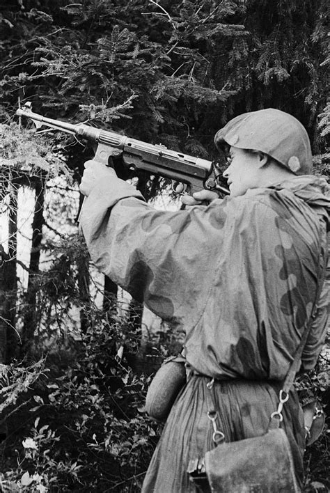 A Red Army Soldier Takes Aim From A Captured German Mp 38 Submachine