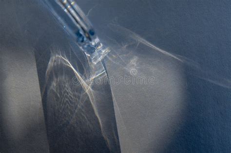 Refraction Of Light Creates Abstract Patterns On A Gray Surface