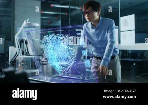 Asian Neural Network Engineer Uses Modern Computer With Transparent Holographic Display Monitor