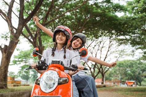 Two Happy Student Girls Riding Motorbike With Airplane Hand Gesture Stock Image Image Of