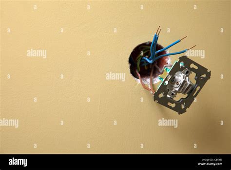 Electrician Installing A Power Socket Wall Background Dirty Socket Hanging Out Of The Wall
