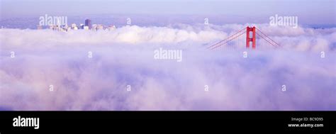 Golden Gate Bridge In The Fog With San Francisco City In The Distance