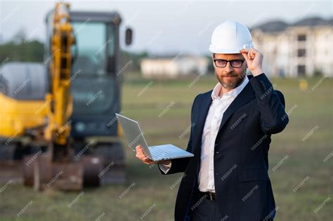 Premium Photo Architect At A Construction Site Architect Man In Helmet And Suit At Modern Home
