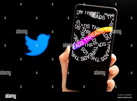 Ukraine, Odesa - July, 7 2023: Hand holding mobile with Threads app running at smartphone screen ...