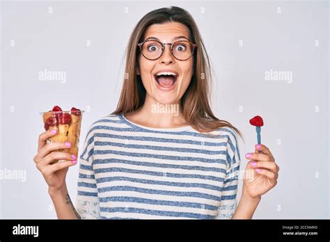 Beautiful Caucasian Woman Eating Fresh And Healthy Fruit Celebrating Crazy And Amazed For