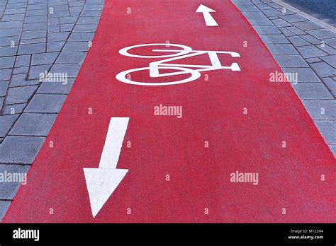 Red Cycle Path With White Markingsbicycle And Direction Arrowsbavaria Red Cycle Path With White Markingsbicycle And Direction Arrowsbavaria