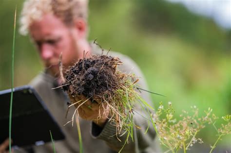 Premium Photo Farmer Collecting Soil Samples In A Test Tube In A Field Agronomist Checking