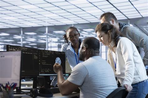 team of engineers working in server farm using pcs to analyze data stock image image of