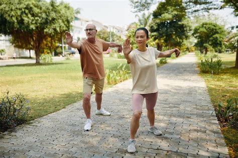 Premium Photo Diverse Couple Exercising In Park