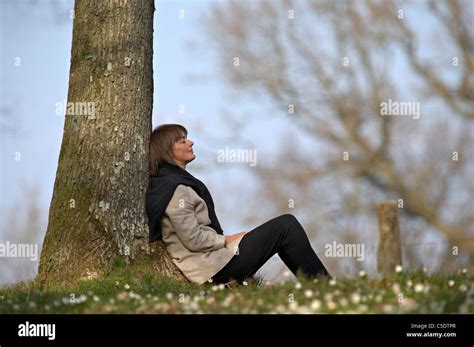 Person Leaning Against A Tree Hi Res Stock Photography And Images Alamy