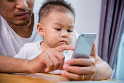 Man Father Working On Laptop Computer And Using Smartphone Technology Stock Photo Image Of