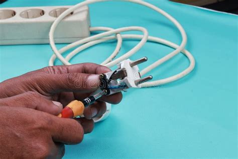 Electrician Holding Screwdriver Working On The Electric Plug Stock