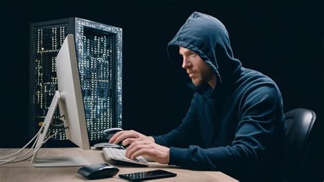 Premium Photo Dangerous Anonymous Hacker Man In Black Hooded Using Computer Breaking Into