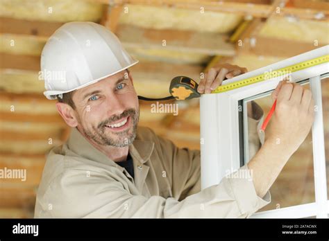 Man Measuring Window Prior To Installation Stock Photo Alamy