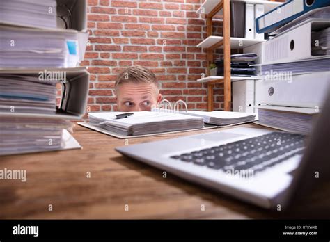 Hiding Under Desk Office Worker