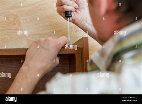 Photo Of Man With Screwdriver Picking Box Stock Photo Alamy