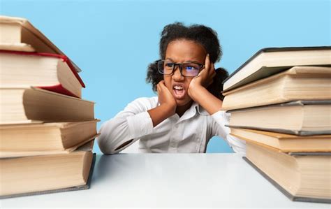 Premium Photo Naughty Schoolgirl Sitting At Books Bored Of Homework Yellow Background