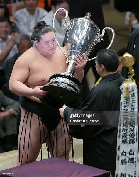 Sumo Wrestler Terunofuji Of Mongolia Receives The Championship Trophy