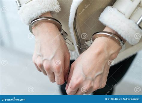 A Woman Who Has Been Arrested And Has Her Hands Handcuffed Behind Her