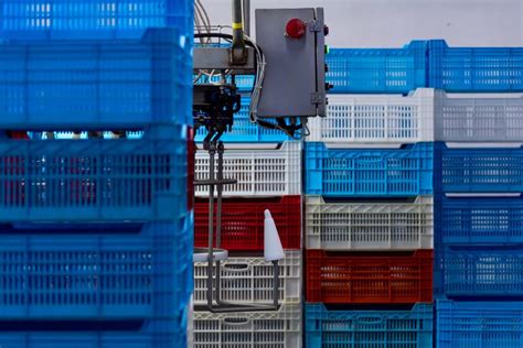 Premium Photo Blue Plastic Crates In A Warehouse With One That Says