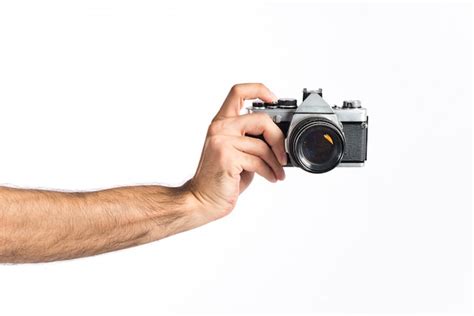 Free Photo Hand Holding A Camera Over White Background