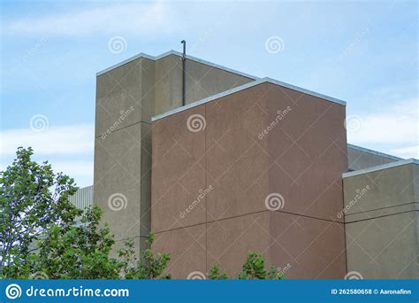 Row Of Stucco Buildings In Late Evening Shade With Blue Sky Background
