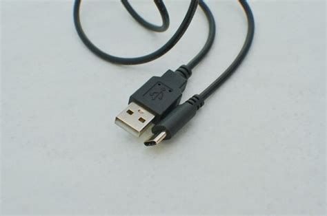 Premium Photo Black Usb Typec Cable Detail Highlighted On A Clear Surface Perfect For Modern